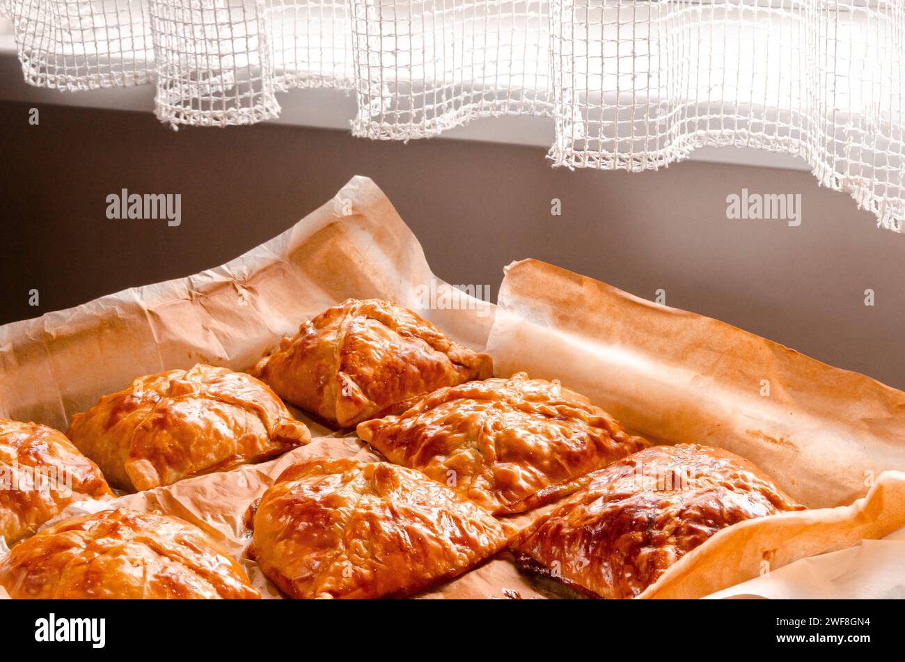 Homemade cakes. Meat pies on parchment Stock Photo - Alamy