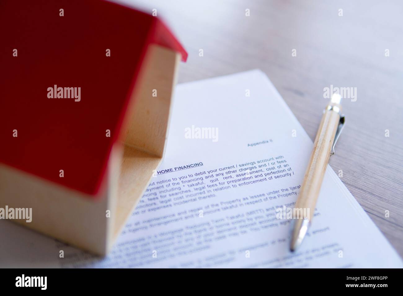 Closeup image of toy house and home financing offer letter from bank ...