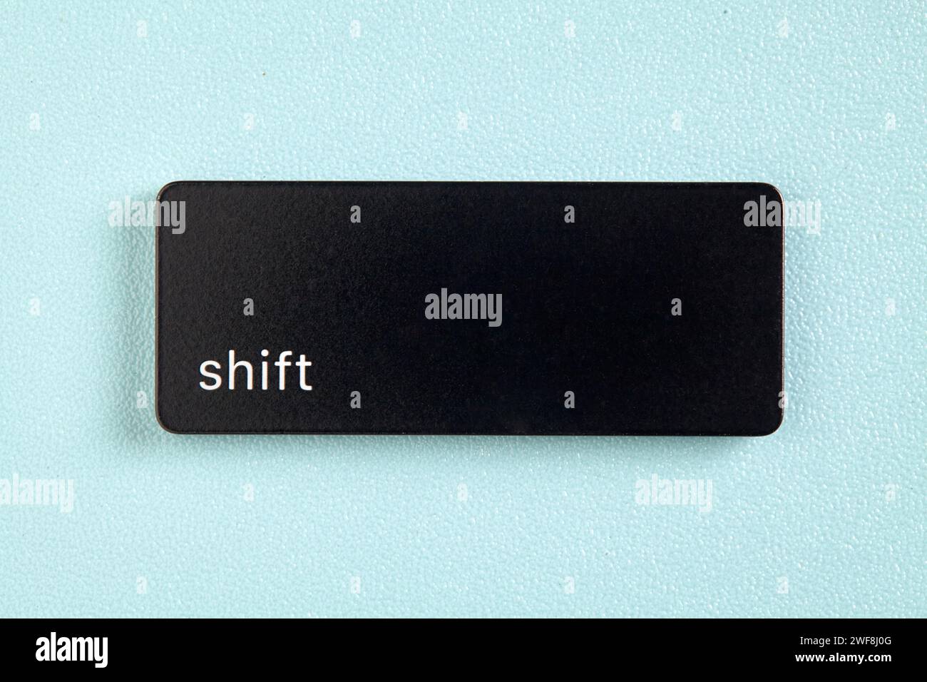Shift key on cyan background Stock Photo - Alamy
