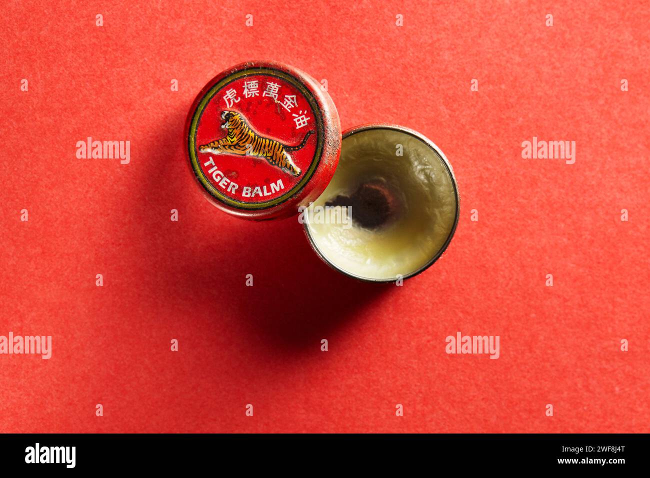 an old packaging for traditional Chinese balm medicine with the lid on ...