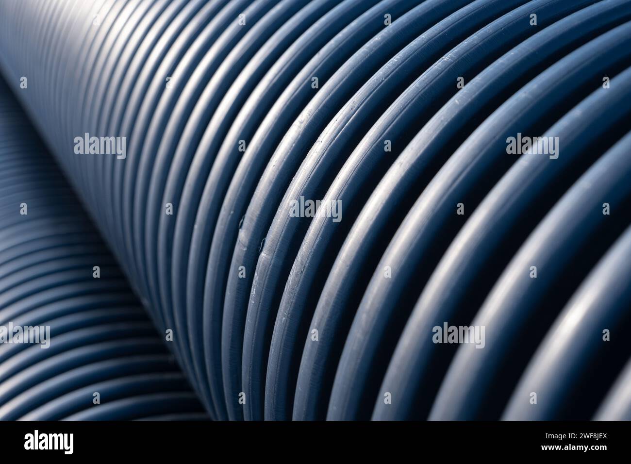 Close-up view on black plastic corrugated drain pipe ribs texture Stock ...