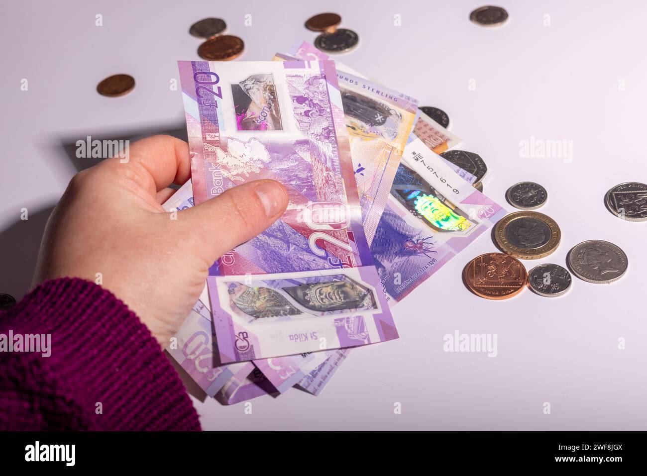 Female hands holding british notes Stock Photo - Alamy