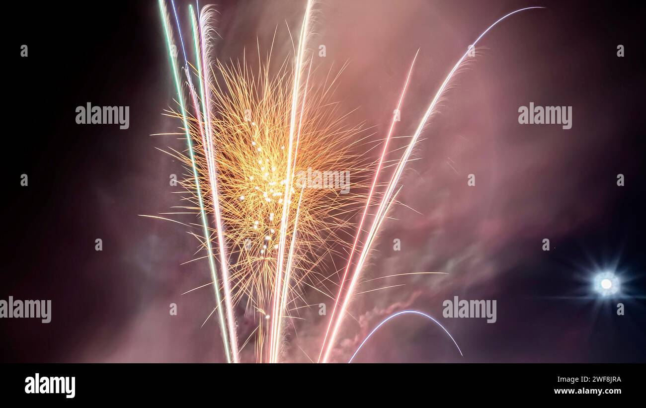 Firework illuminates the night sky with stars Stock Photo - Alamy