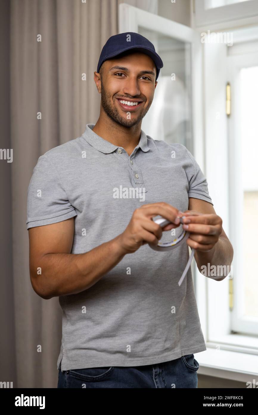 Man holding sealing foam tape for window in his house Stock Photo - Alamy
