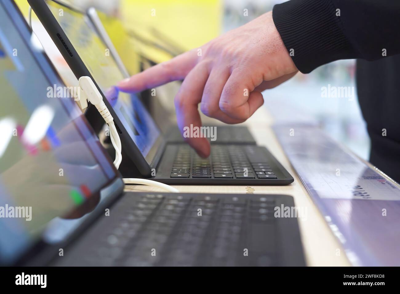 Buyer checking laptops in a computer store Stock Photo - Alamy