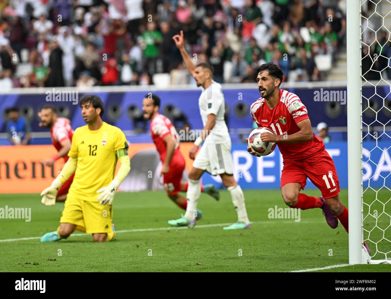 Doha, Qatar. 29th Jan, 2024. Jordan's Yazan Alnaimat (R) celebrates ...