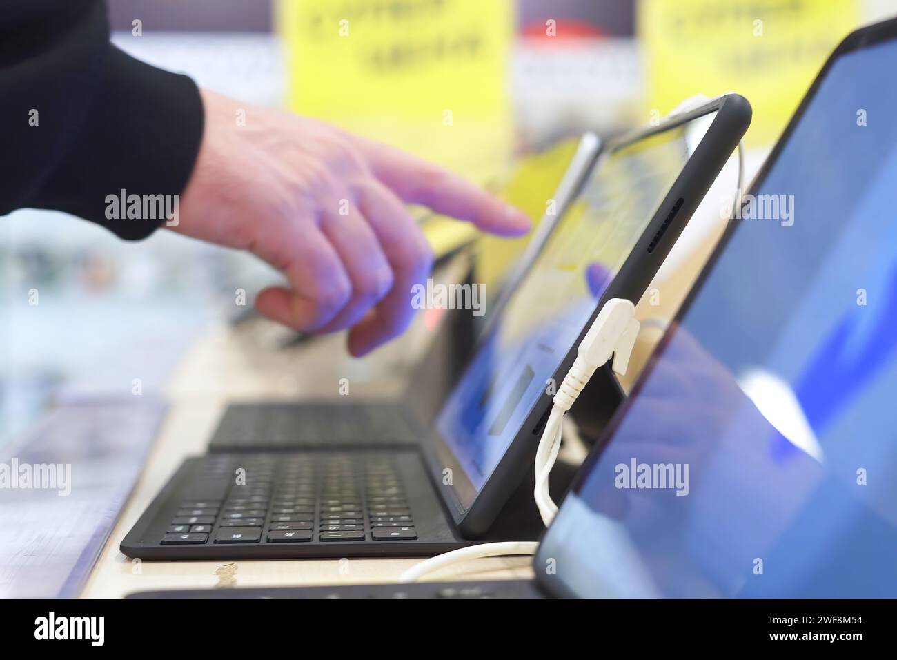 Buyer checking laptops in a computer store Stock Photo - Alamy