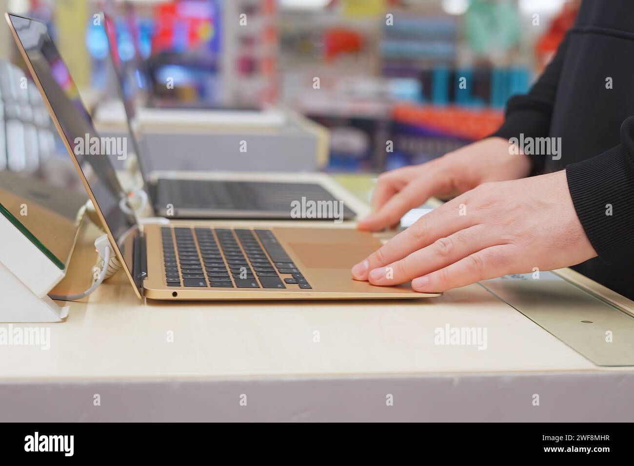 Buyer checking laptops in a computer store Stock Photo - Alamy