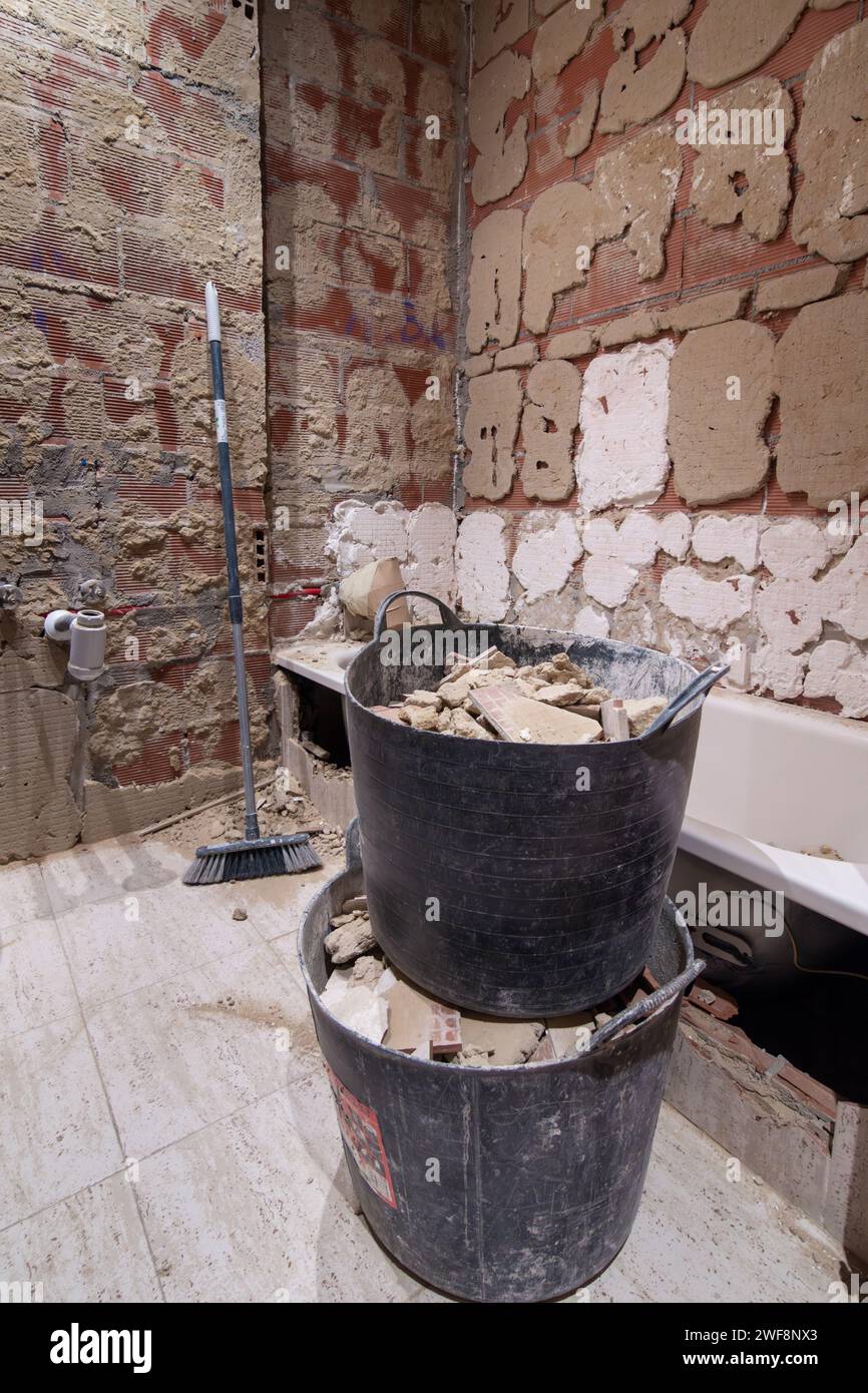 Baskets full of rubble in the foreground in a bathroom renovation. Home ...