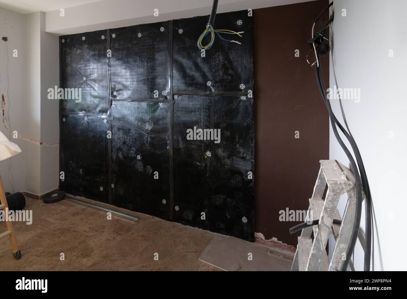 Room in the process of insulation walls with visible materials ...