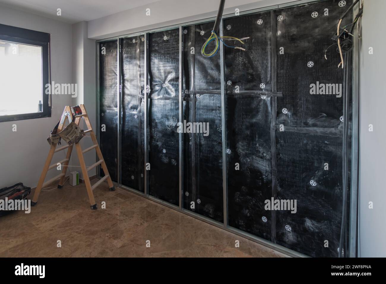Bedroom in the process of insulating walls with acoustic insulation ...