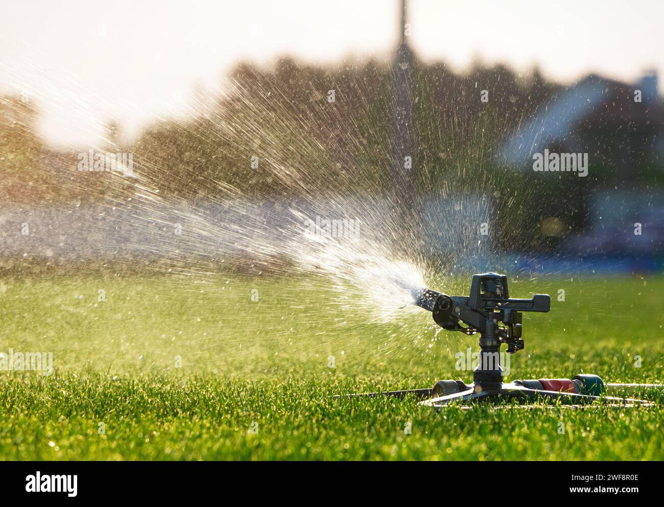 Automatic sprinkler watering in the lawn. Irrigation system Stock Photo ...