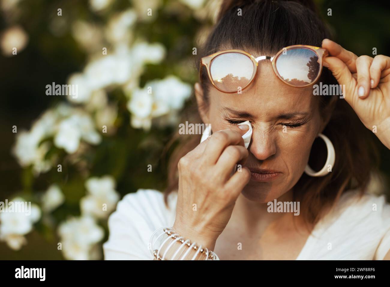 Summer time. sad stylish 40 years old woman in white shirt with ...