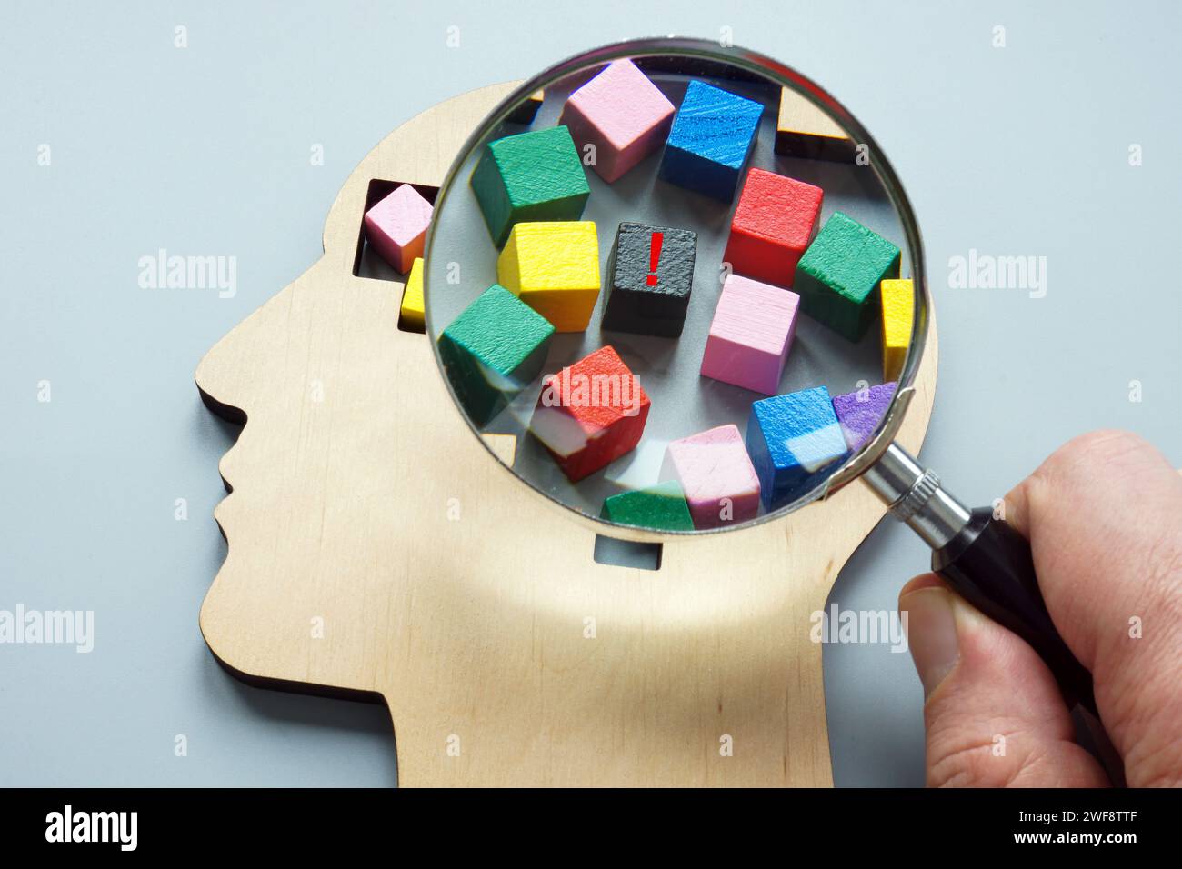 Psychoanalysis and negative emotions. A hand with a magnifying glass ...