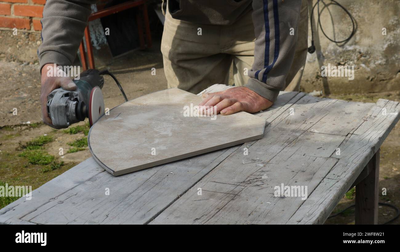 Hand holds tile cutter tool hi-res stock photography and images - Alamy