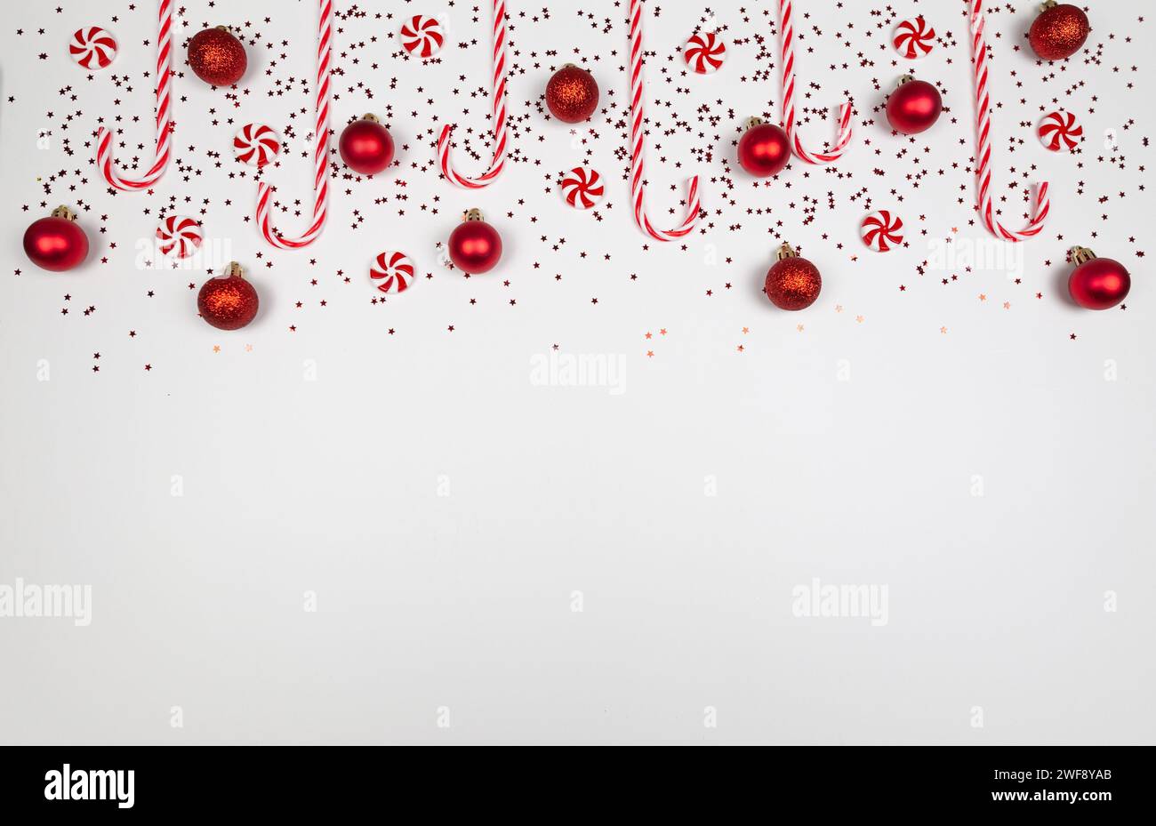 Christmas composition, red and white sweets, candy canes, round candies ...