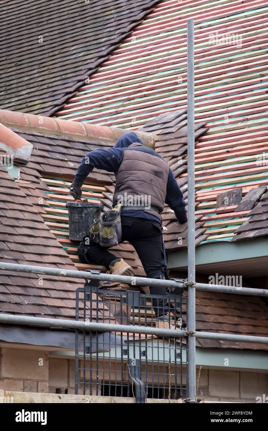 Roofer laying roof tiles at roof junction hi-res stock photography and ...