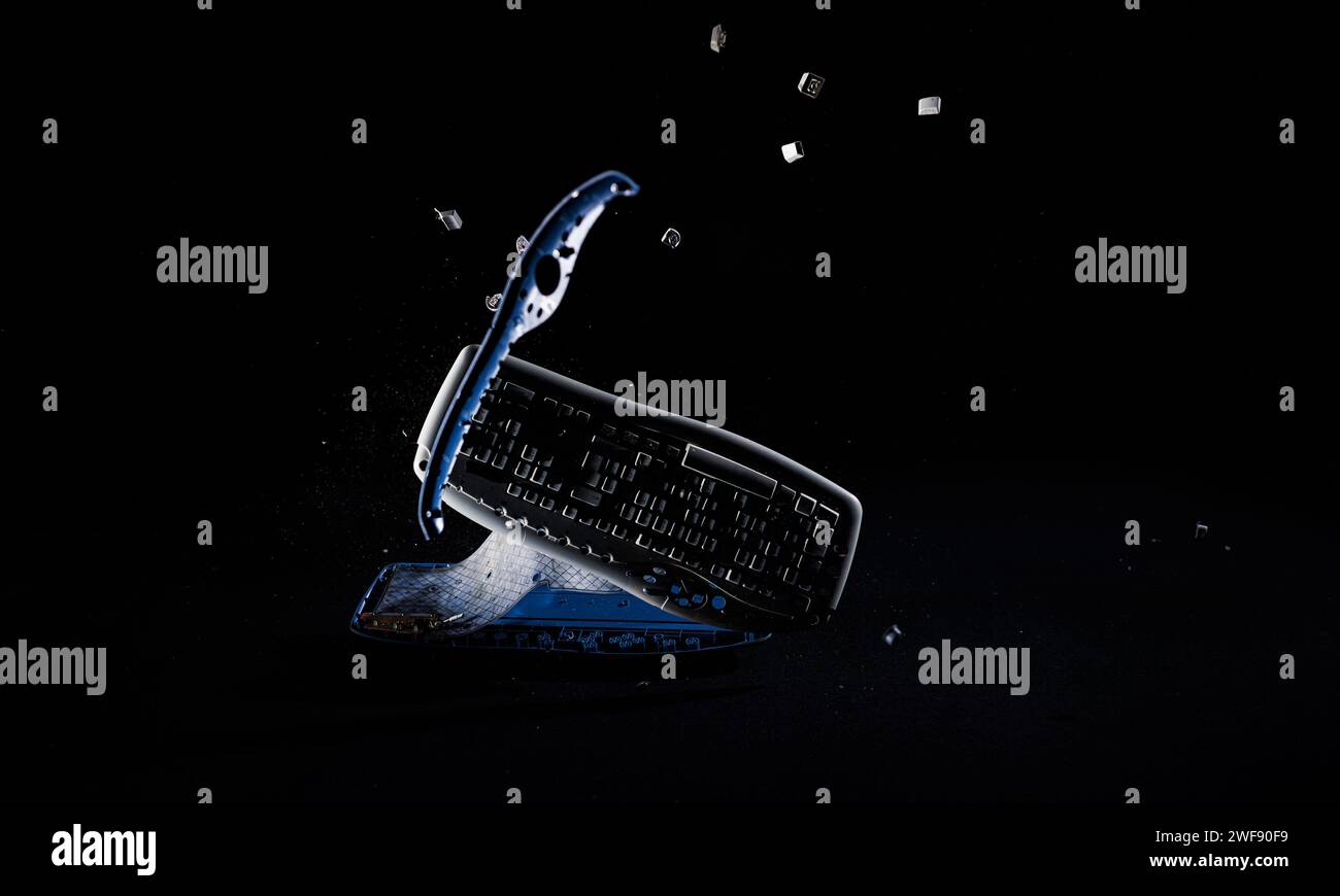 Destroying and hitting a computer keyboard on a floor, particles flying ...