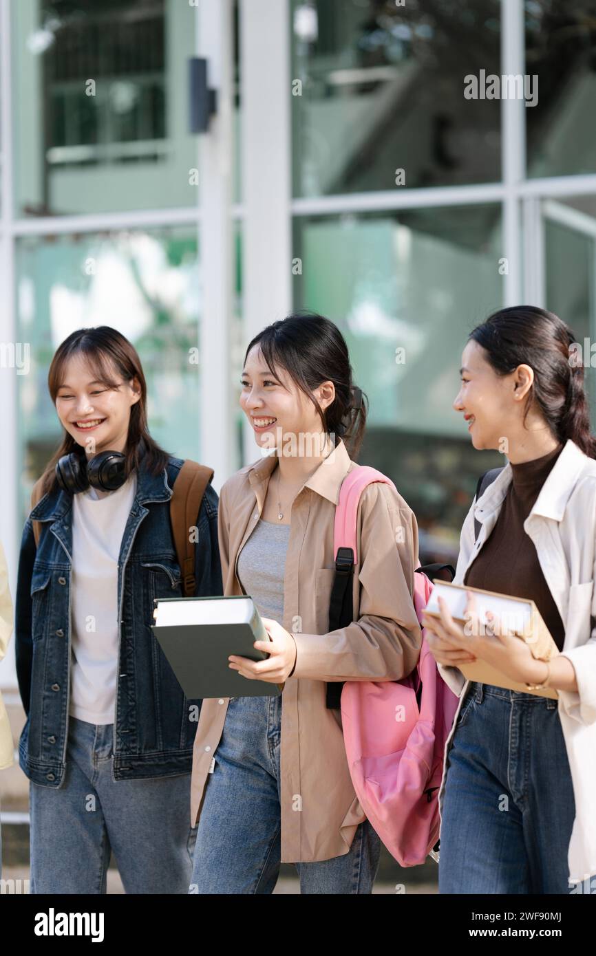 Group of Young Asian student walking and talking at university before ...