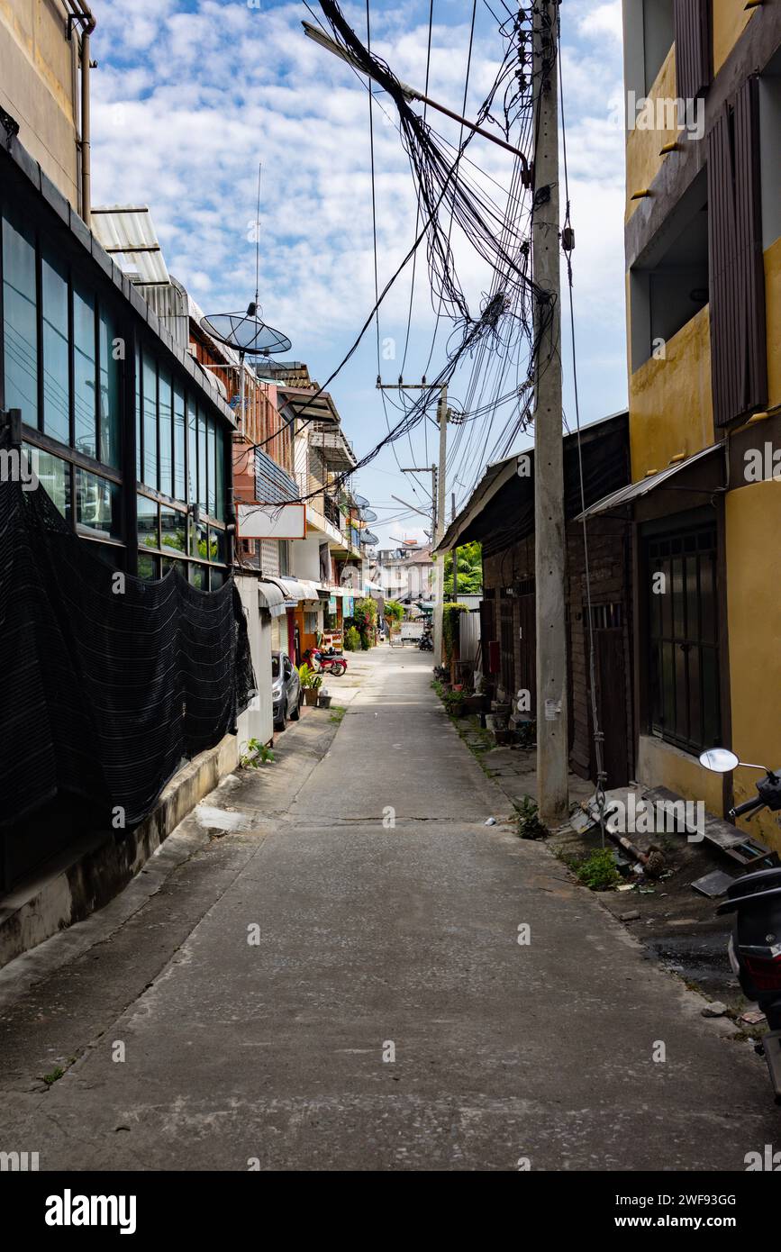 A narrow alleyway with a motorcycle parked on the side, creating a ...