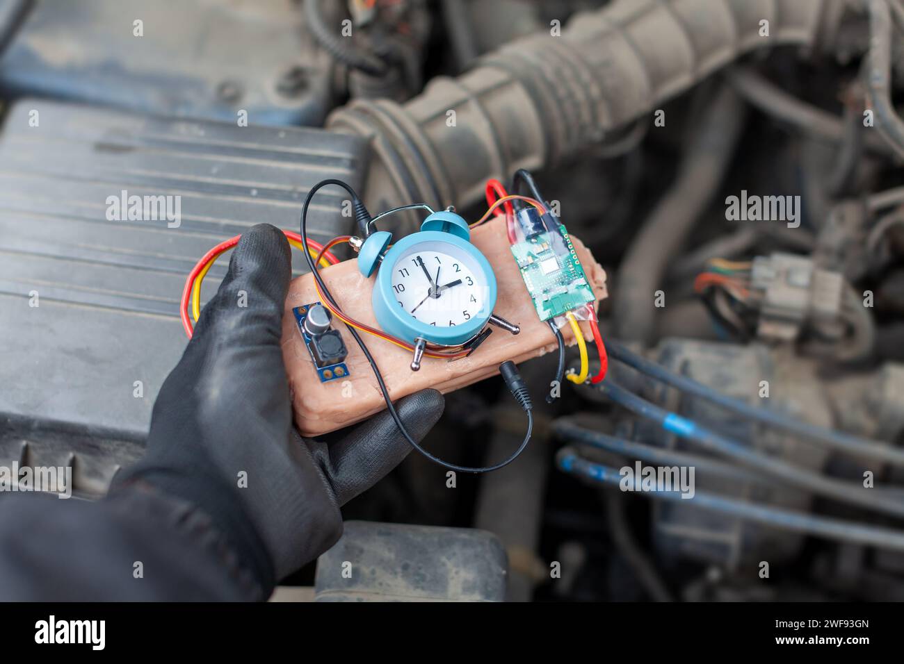 terrorist placing a time bomb in vehicle engine Stock Photo - Alamy