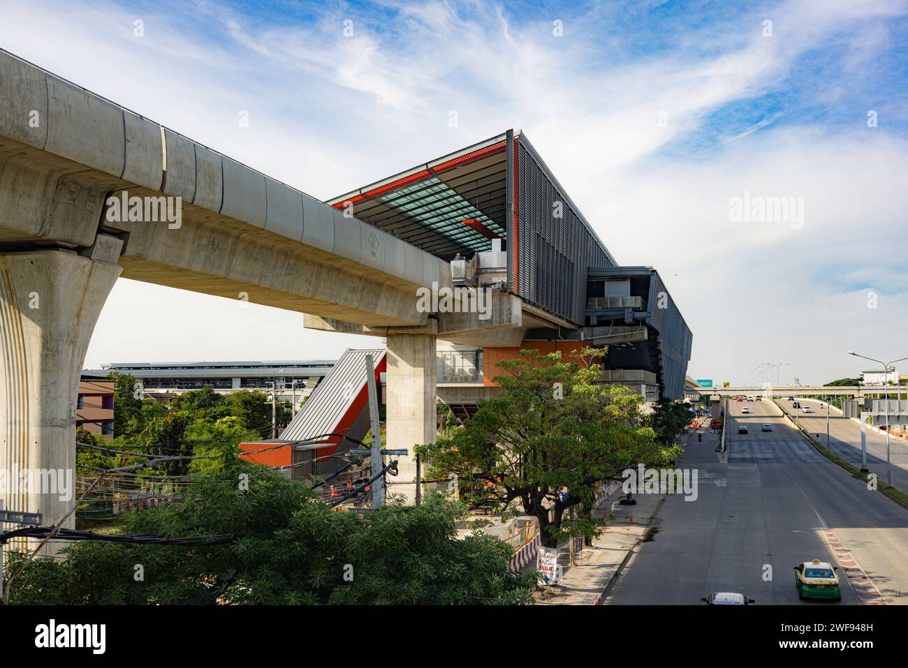 This photo captures a street with a bridge spanning over it, showcasing ...