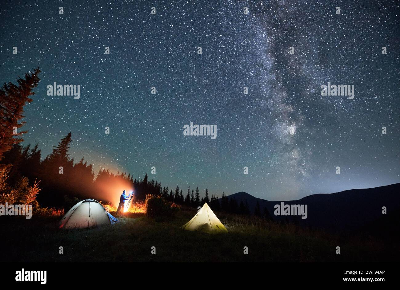 Male photographer taking pictures of Milky way. Man doing photo shoot ...