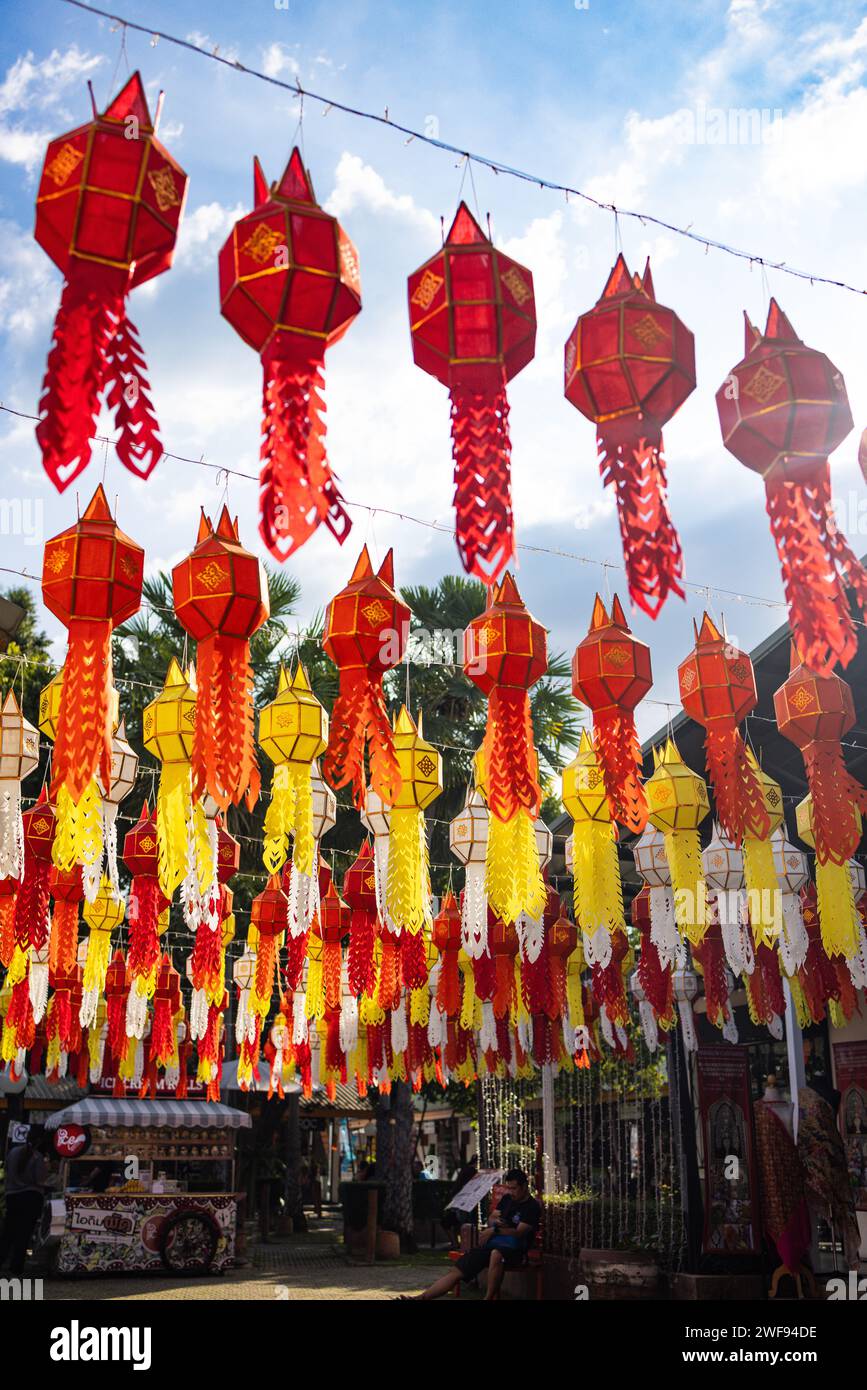 A vibrant and lively scene with multiple red and yellow lanterns ...