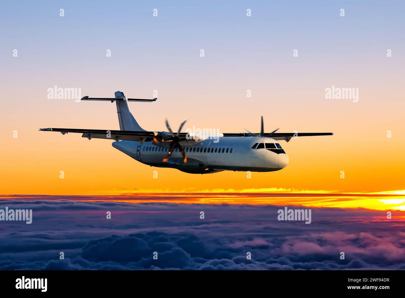 White passenger turboprop aircraft fly in the sunrise sky Stock Photo ...
