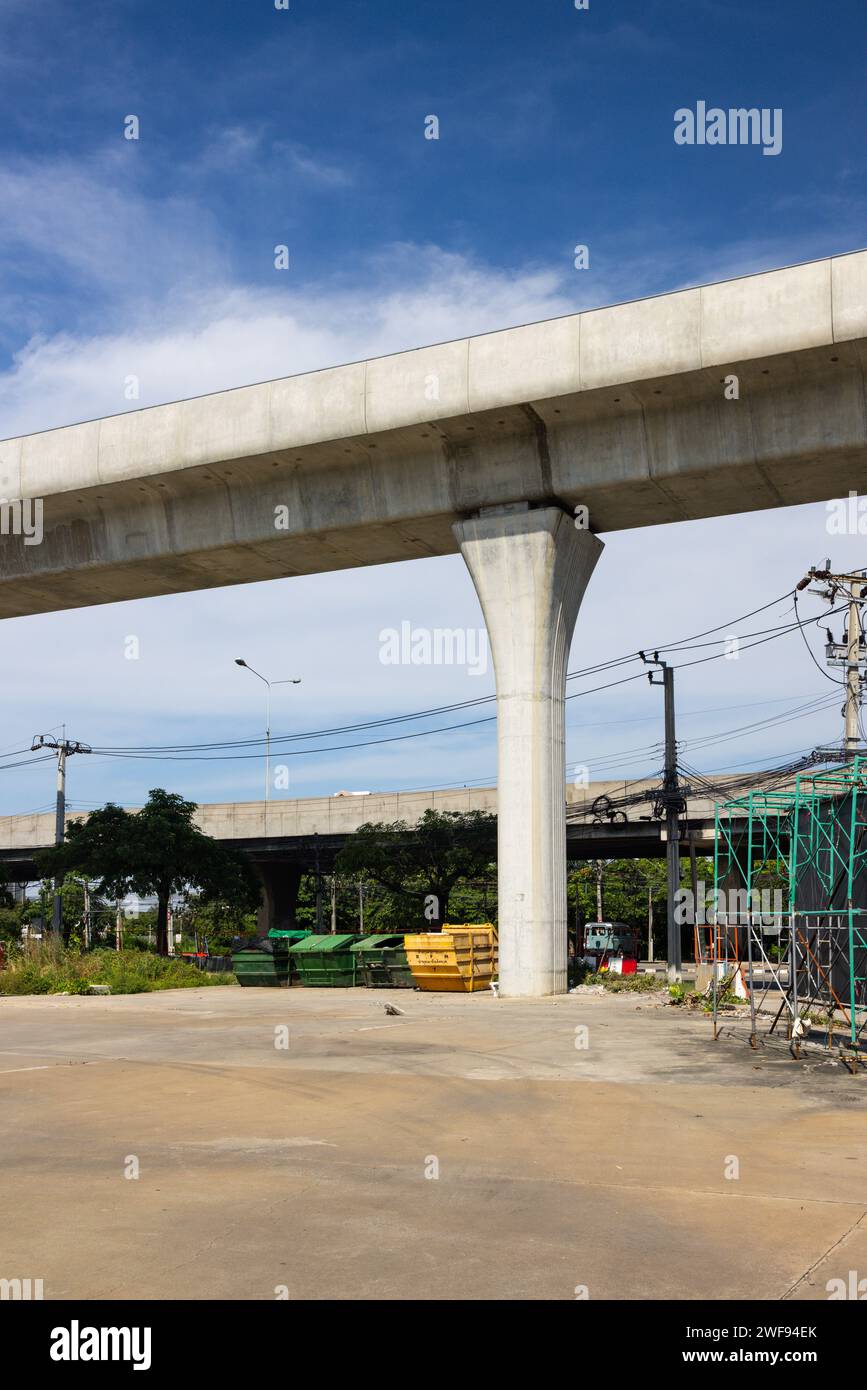 This photo shows a view of an overpass from a parking lot in an urban ...
