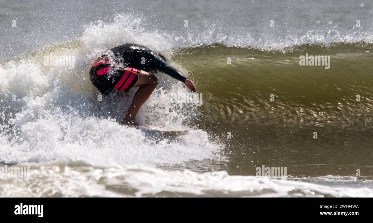 One male surfer trying to get under the break of a wave unsuccessfully ...