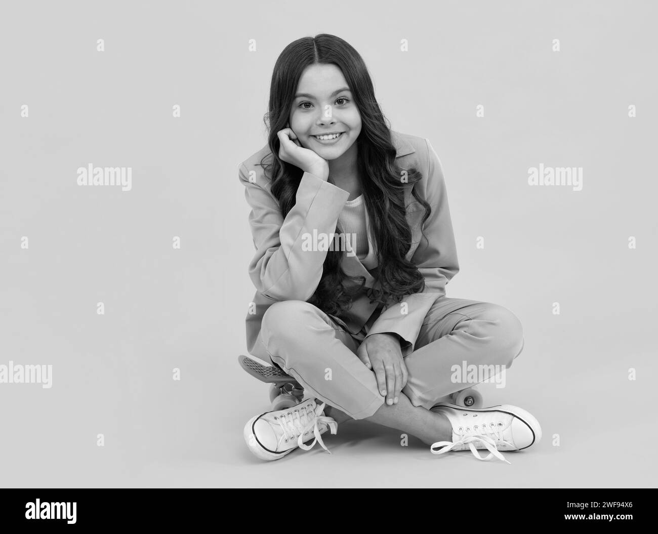 Beautiful and fashion teenager child girl in moder suit posing with a ...