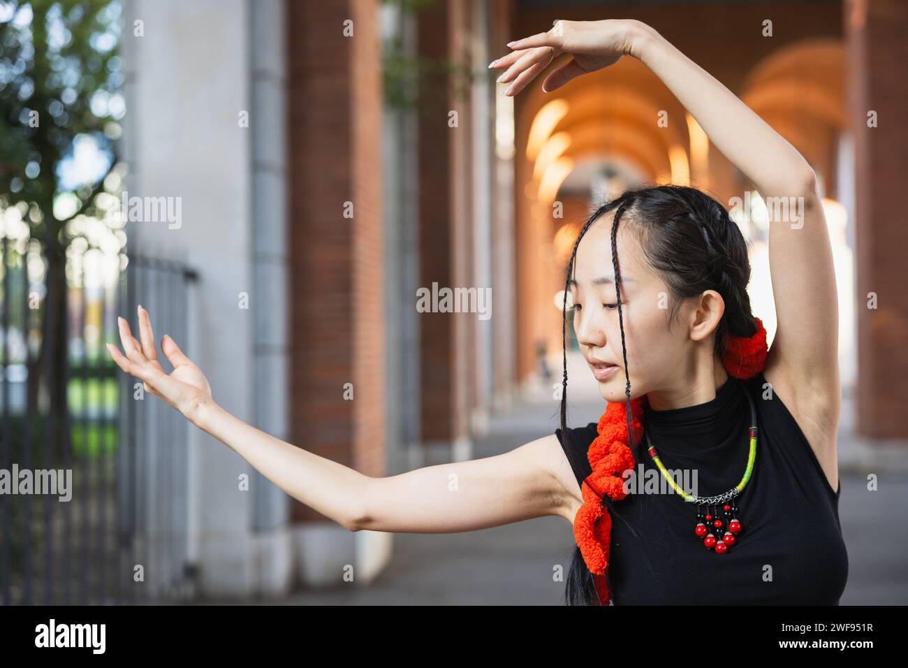 Captivating female dancer in an urban setting, demonstrating a delicate ...