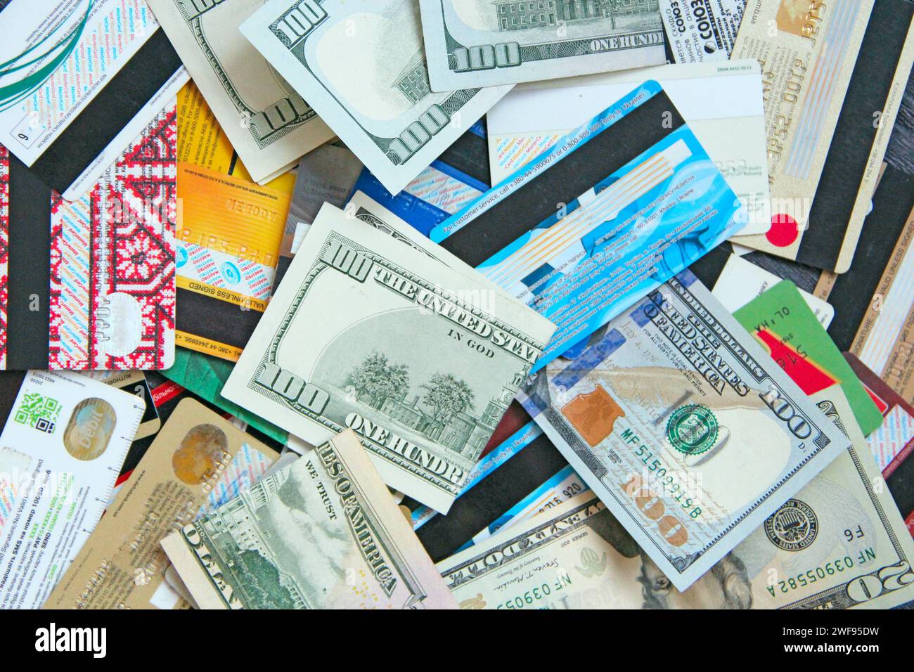 Hundred dollar notes and credit cards. Pile of credit cards in dollars ...