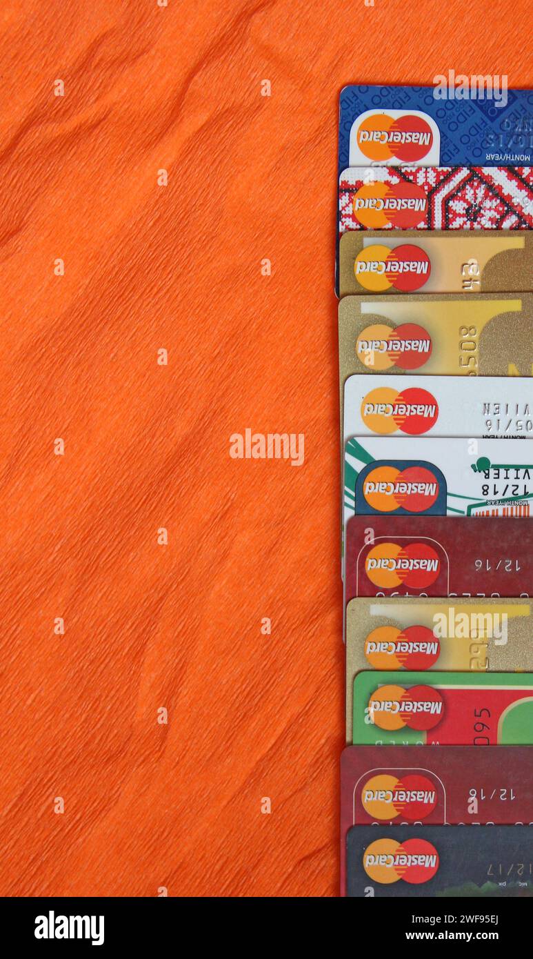 different credit cards with Mastercard brand logo. Close up of many ...