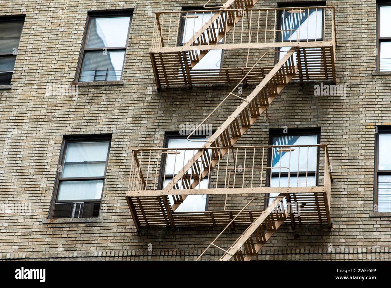 Facades of typical brick buildings and fire escapes in the Bronx ...