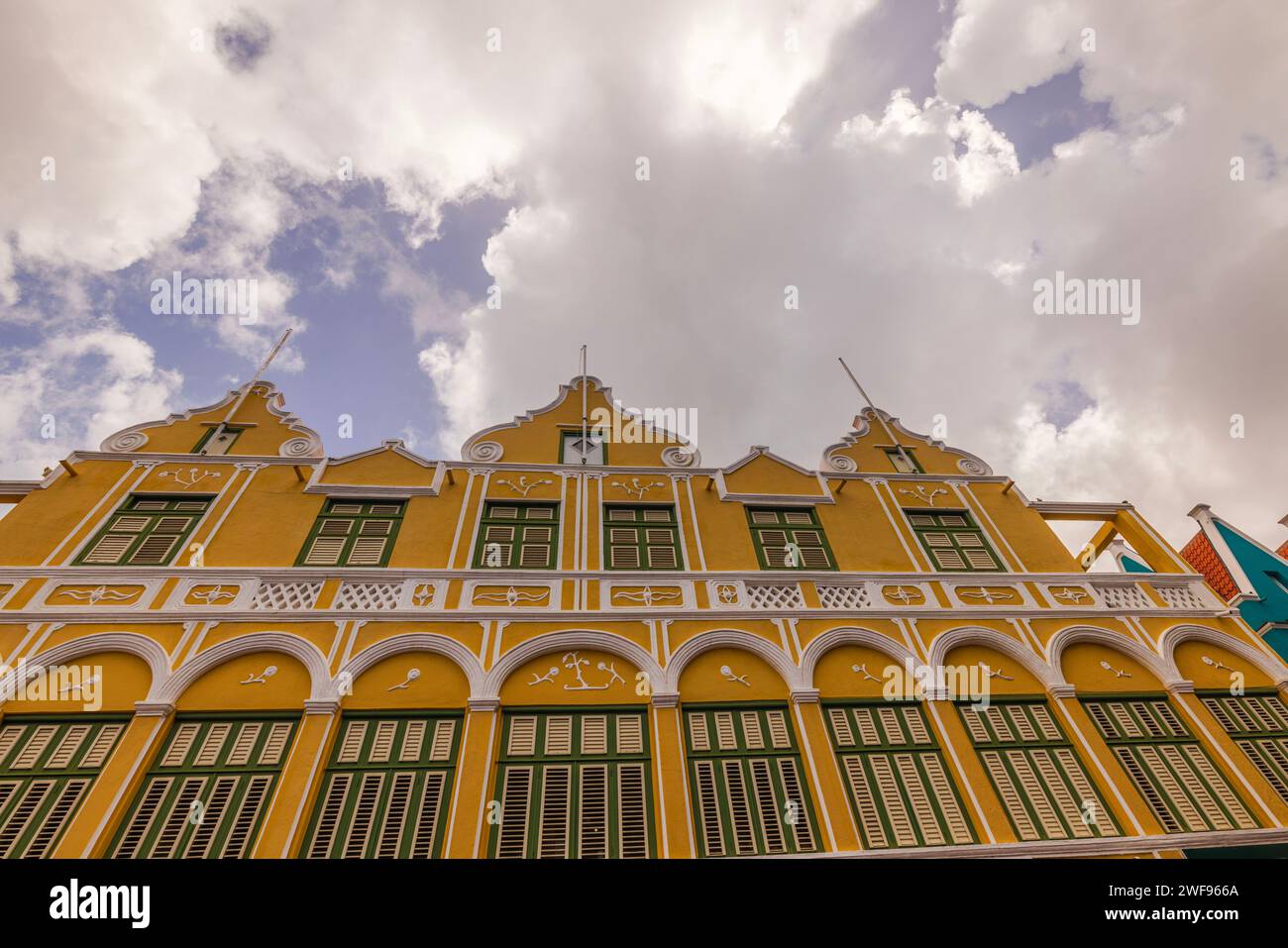 Yellow house with captivating exterior architecture against the ...
