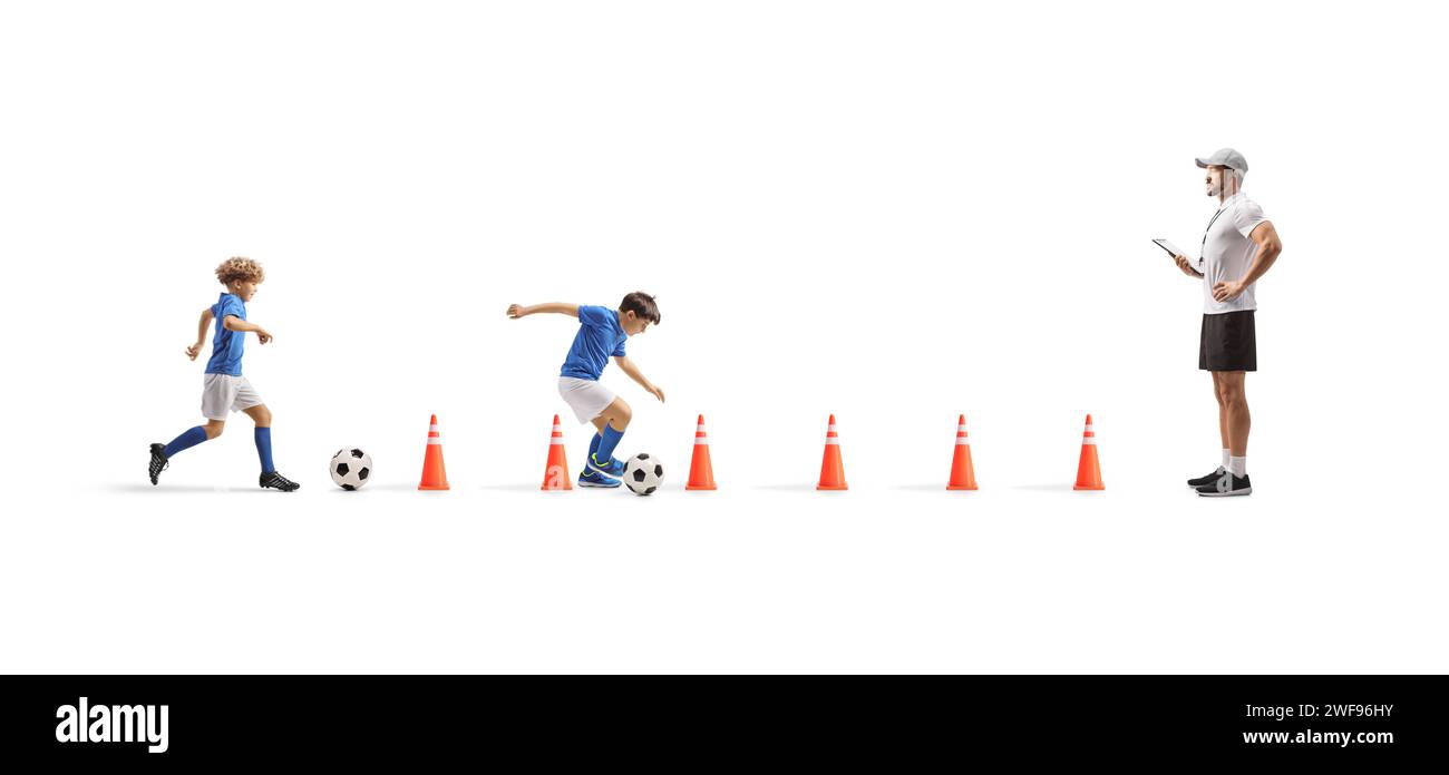 Boys at a football camp training aguility with coach isolated on white ...