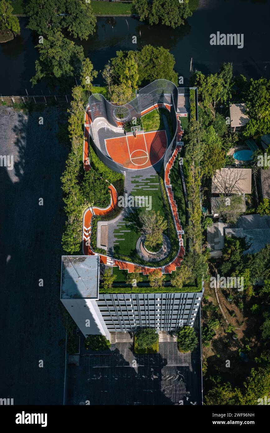 This photo captures an aerial view of a rooftop basketball court ...