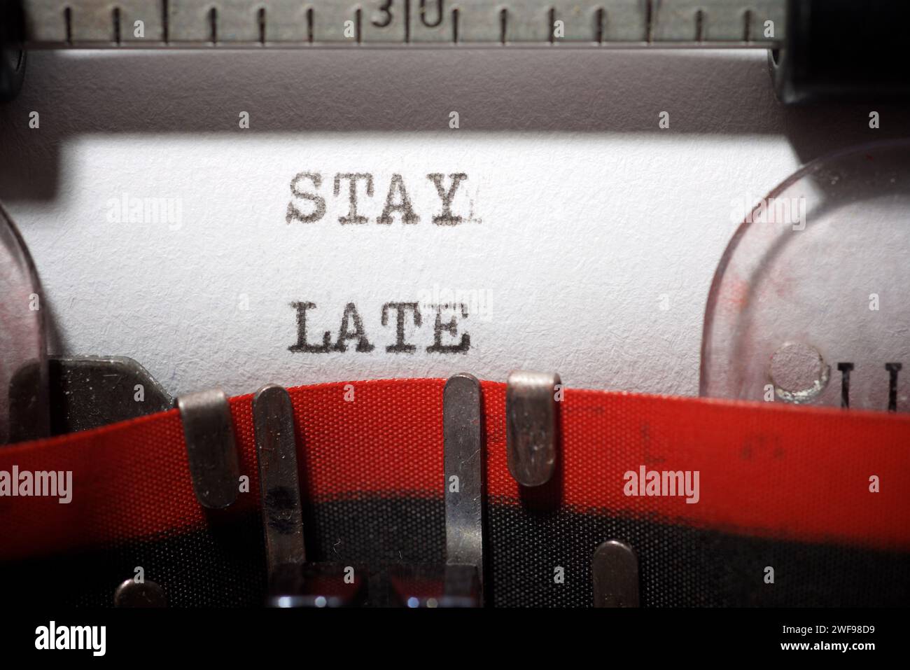Stay late text written with a typewriter Stock Photo - Alamy