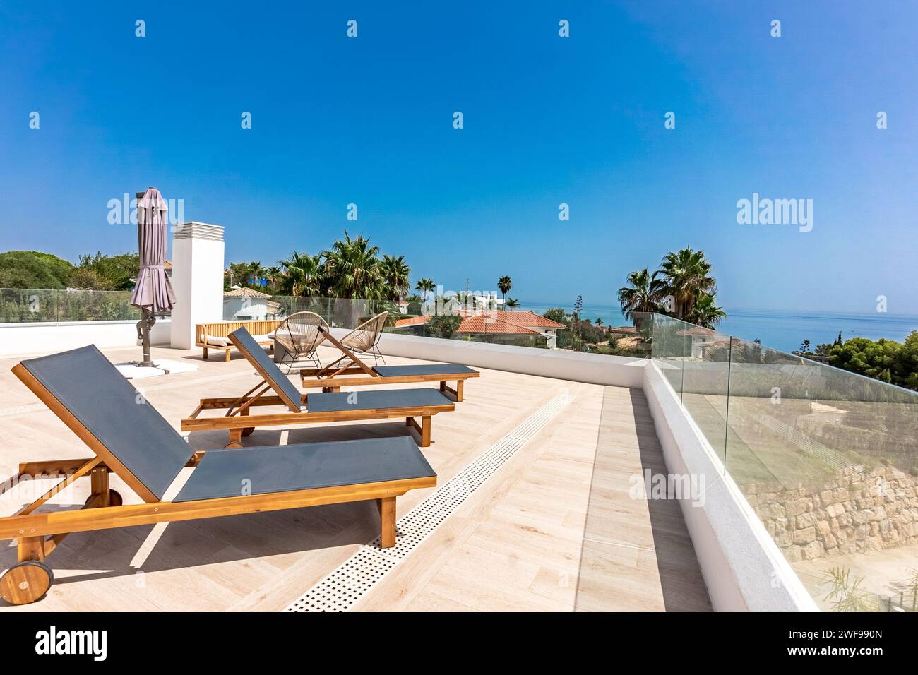 a luxury rooftop terrace with sun lounges and ocean view Stock Photo ...