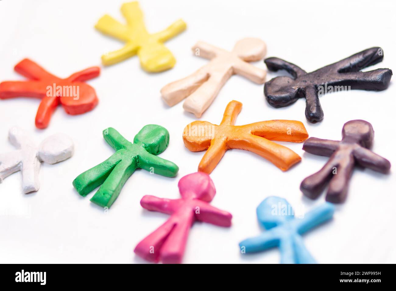 colorful clay people on white background Stock Photo - Alamy