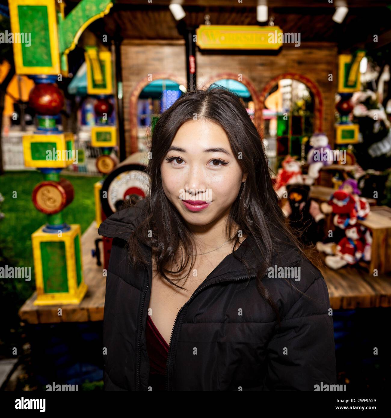 Close up of Beautiful Young Asian Woman Standing in Front of an Outdoor Holiday Display Stock ...