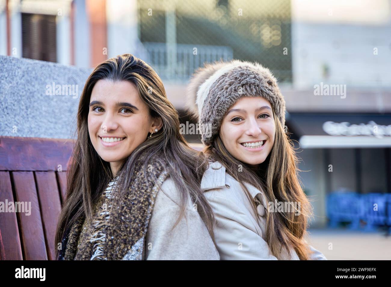 Two beautiful smiling women looking at the camera with a perfect smile ...
