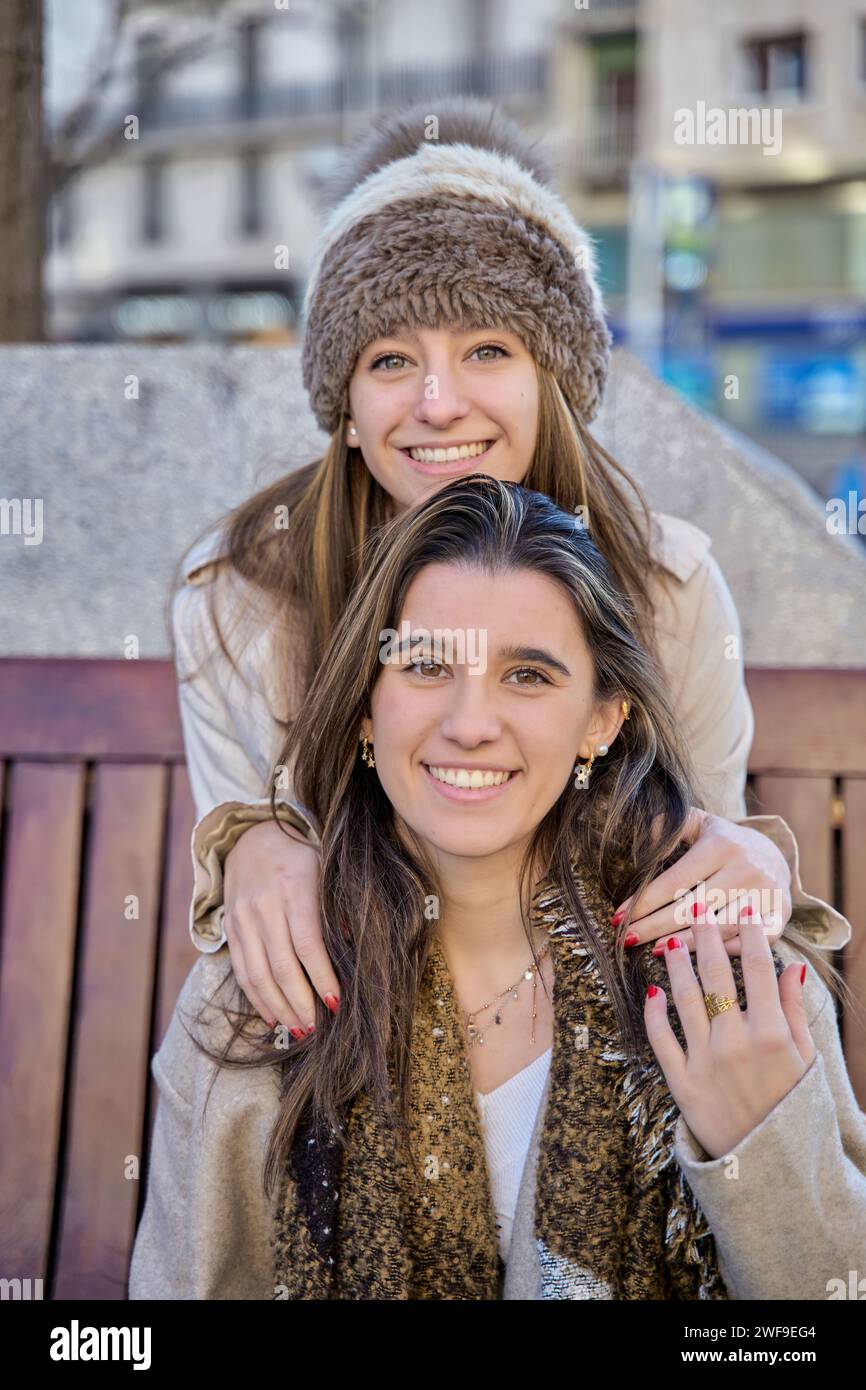 Close-up close-up portrait of two smiling friends hugging, enjoying a ...