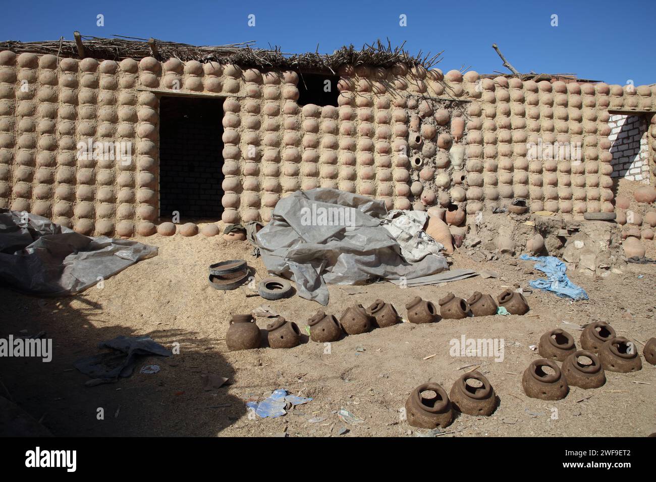 pottery, rubish, buildings in a village Stock Photo - Alamy