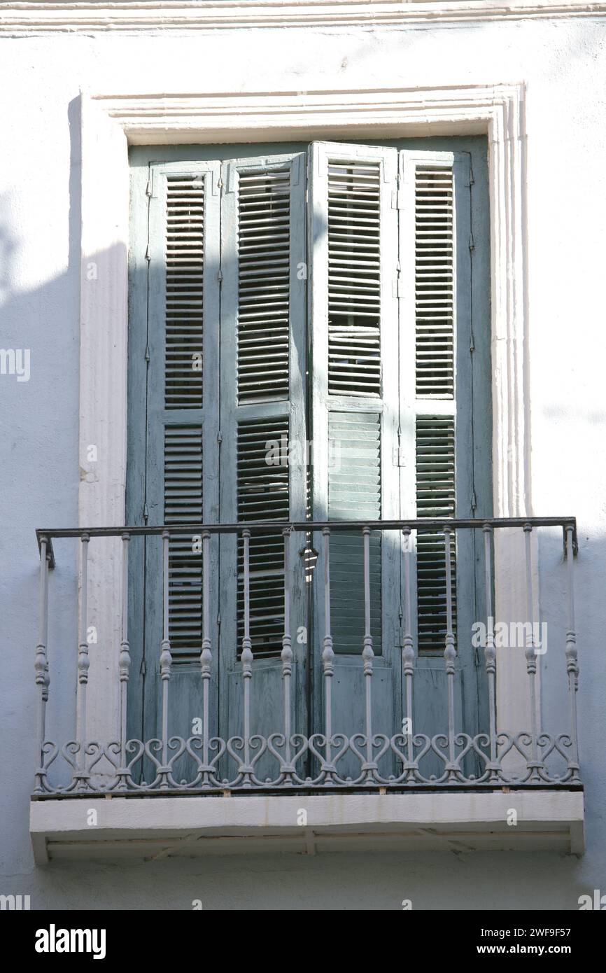 Shutters in the heat of the afternoon sun.Stylish powder blue painted ...