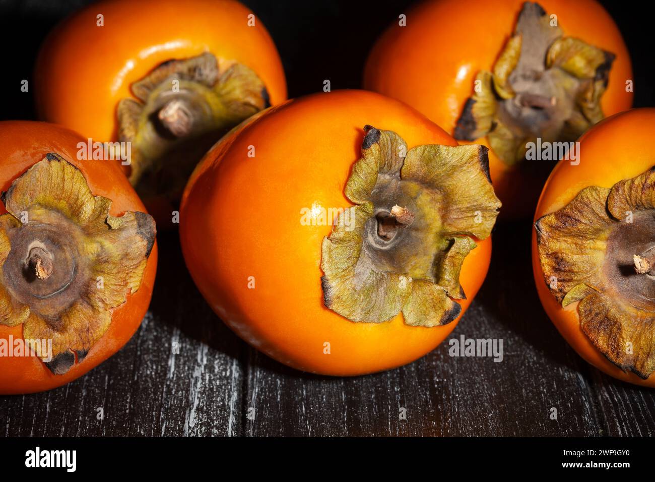 Persimmon group on black hi-res stock photography and images - Alamy