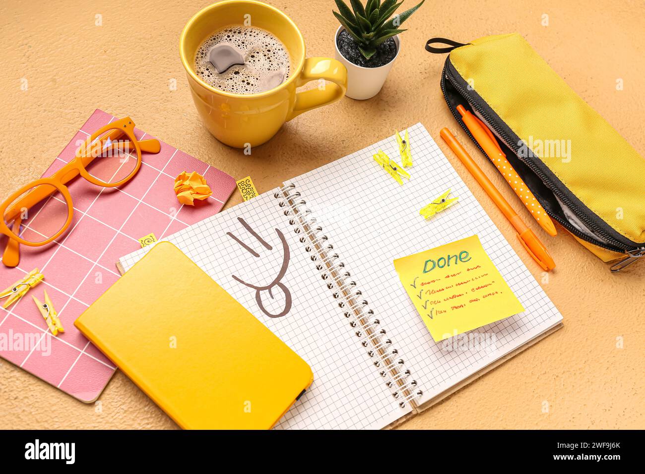 Sticky note with word DONE, stationery, coffee cup and eyeglasses on ...