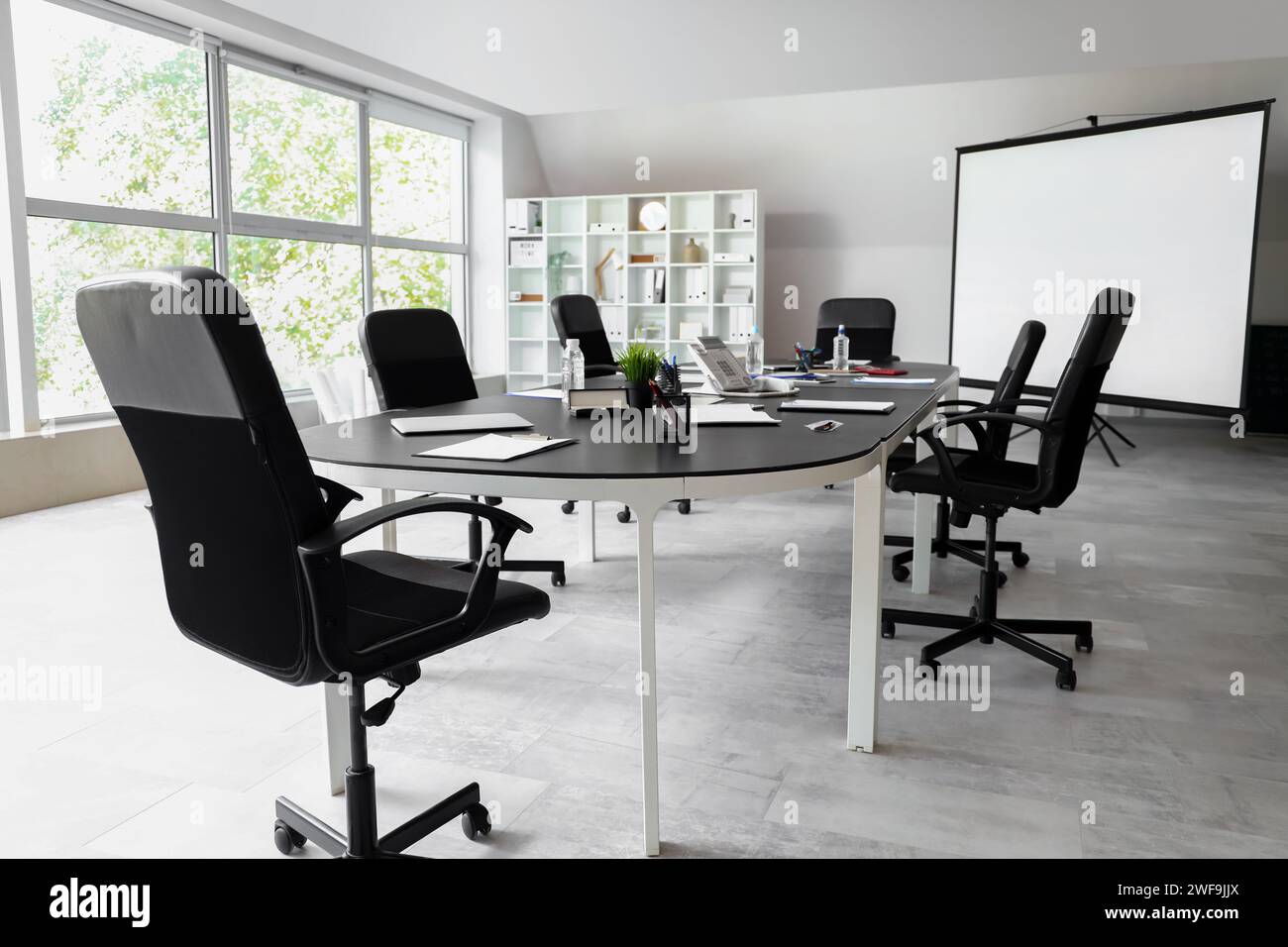 Interior of conference room with desk and shelf unit Stock Photo - Alamy